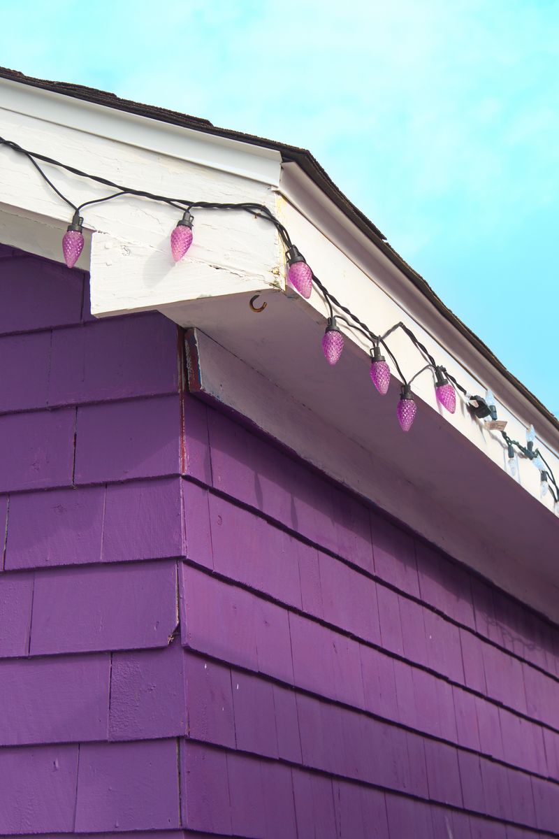Download wallpaper 800x1200 building, facade, roof, garland, purple ...
