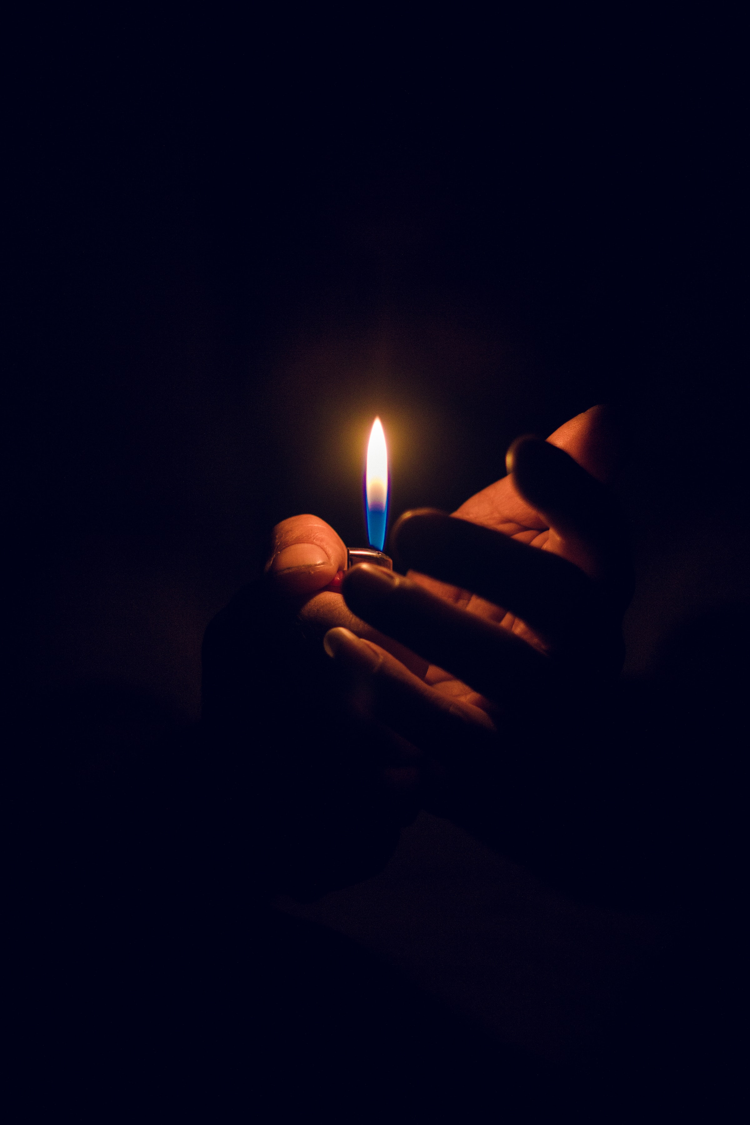 Download wallpaper 2400x3600 candle, hand, flame, dark hd background