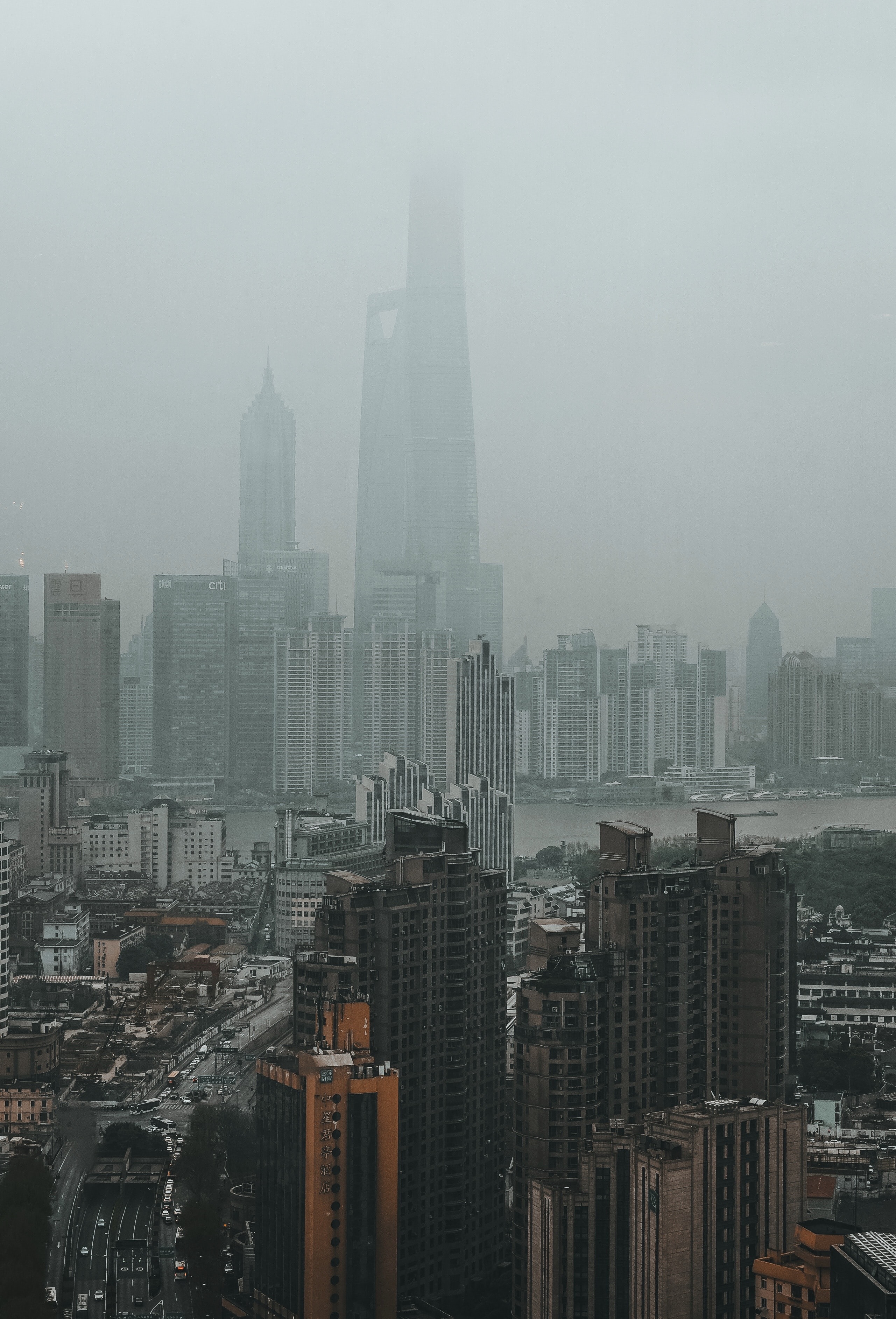 Download wallpaper 2561x3769 city, buildings, fog, aerial view hd ...