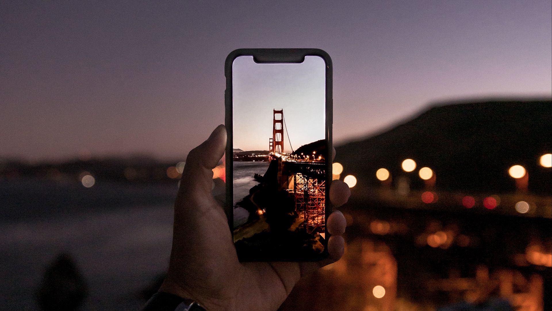 Download wallpaper 1920x1080 hand, phone, photo, bridge, sunset, lights ...