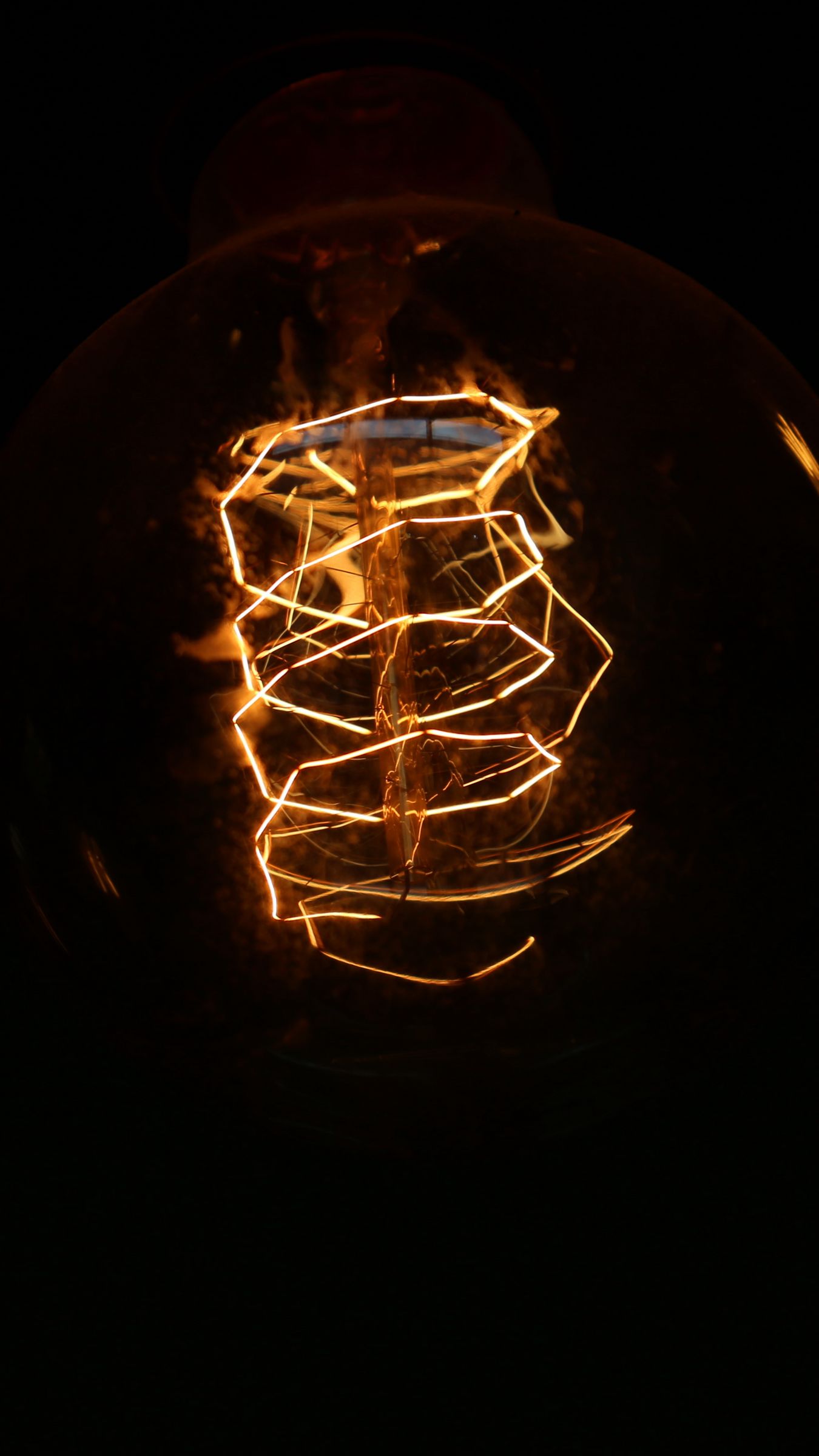 Download Wallpaper 1350x2400 Light Bulb Electricity Spiral Dark