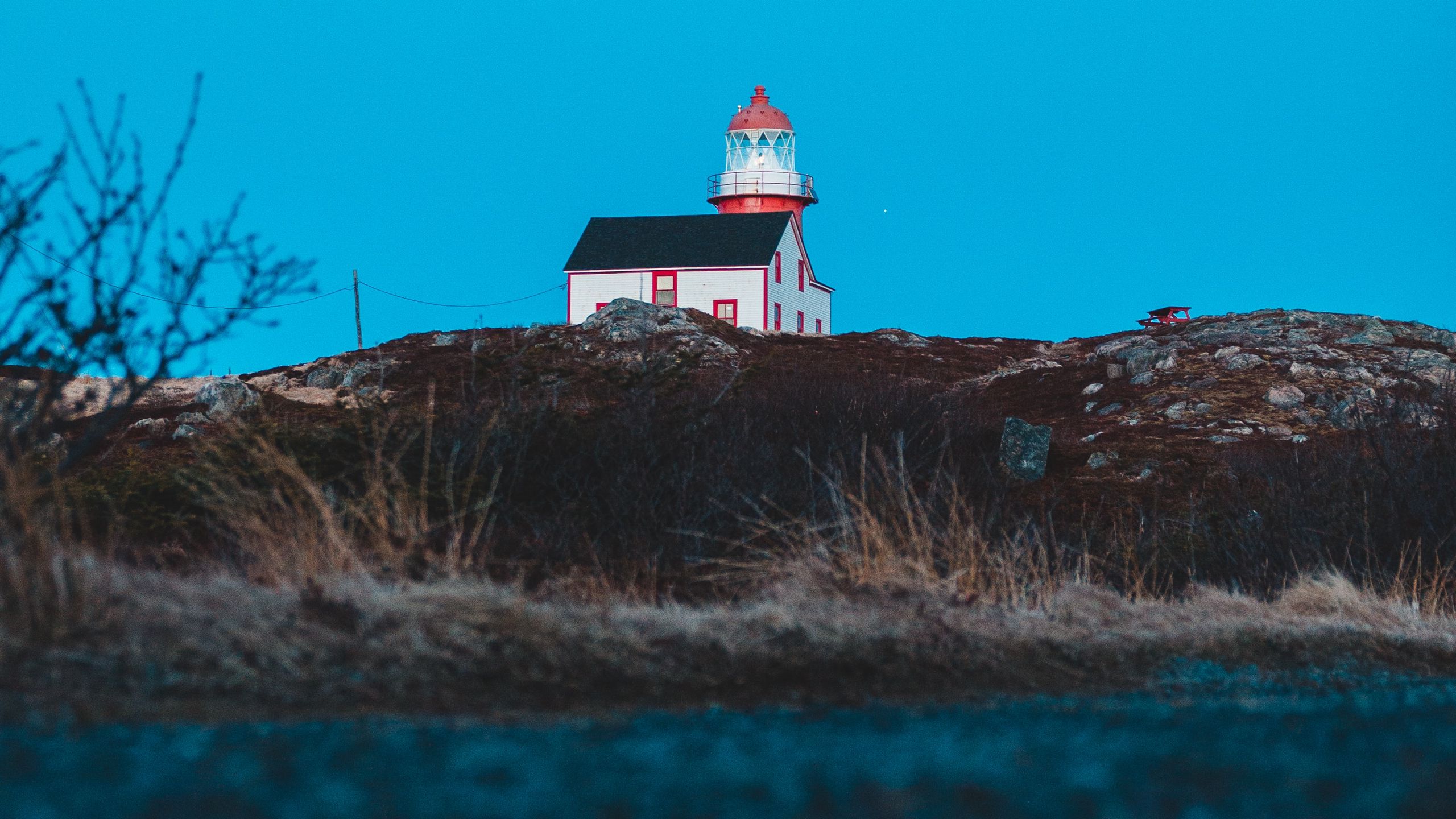 Download wallpaper 2560x1440 lighthouse, building, hill, water ...