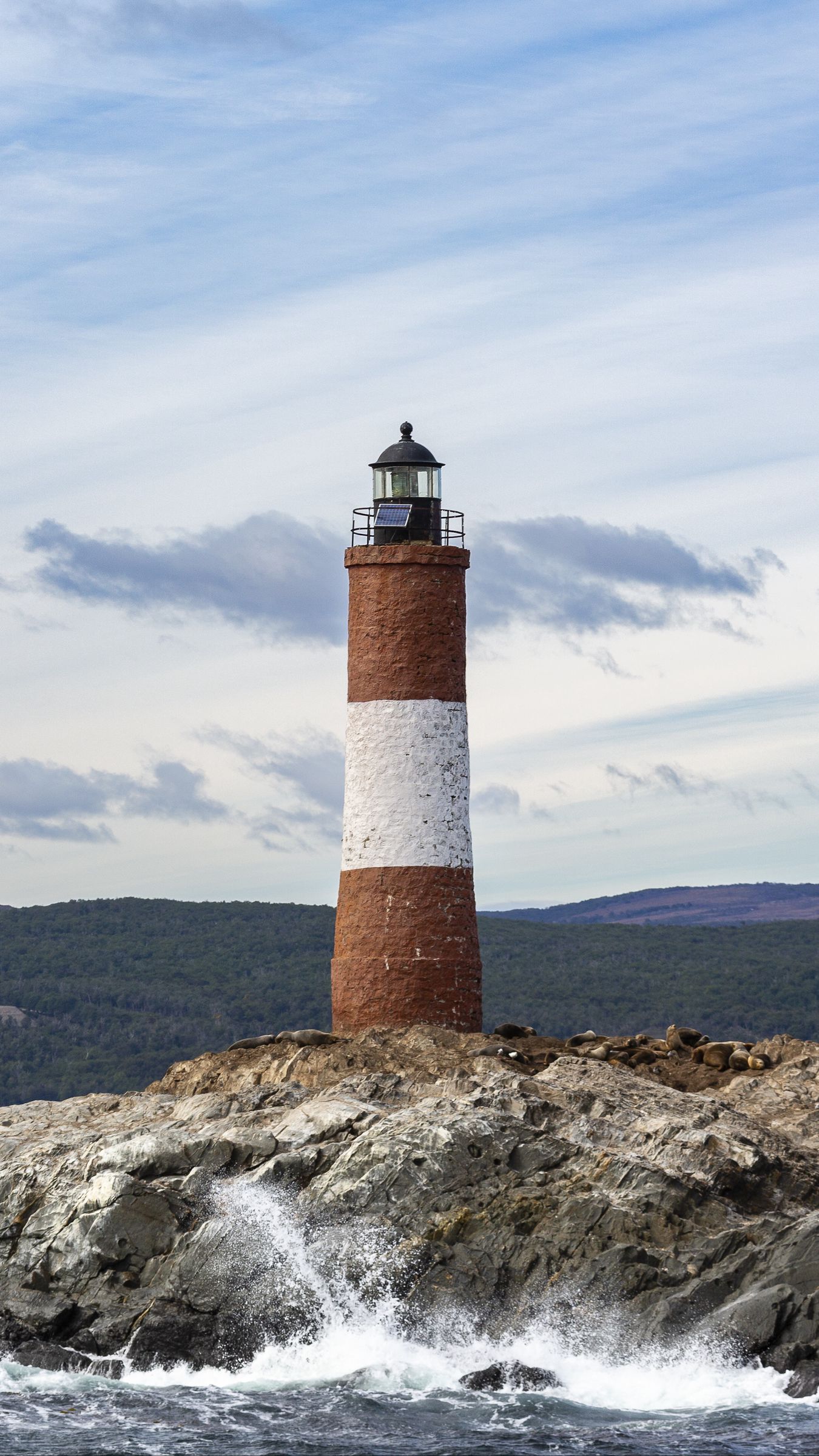 Download wallpaper 1350x2400 lighthouse, rock, sea, spray, mountains ...