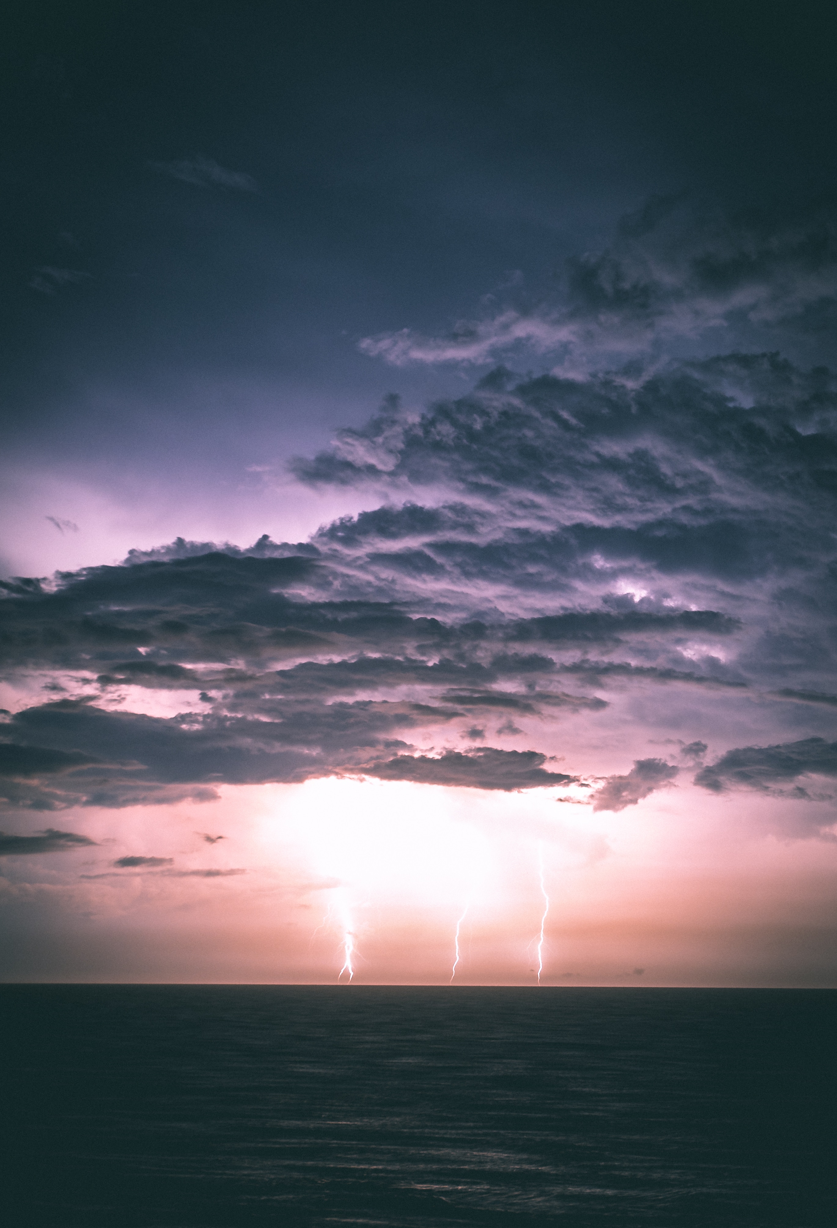 Download wallpaper 2739x4016 lightning, horizon, sea, night, clouds ...