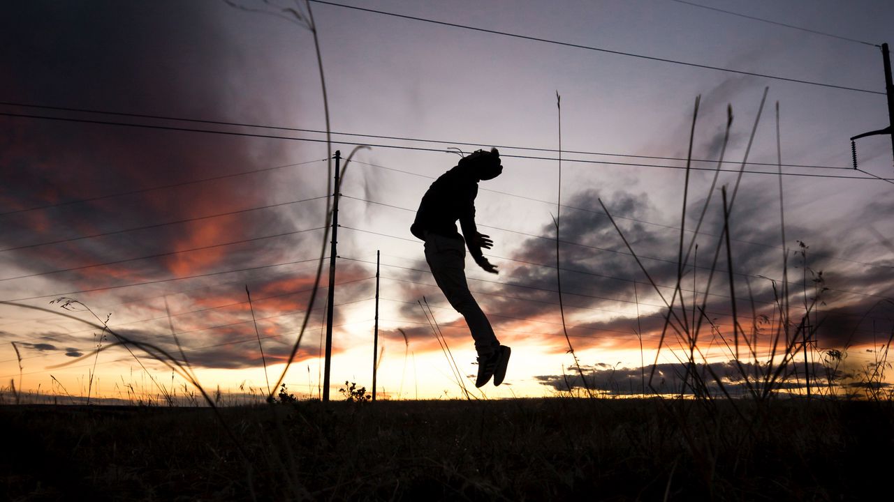 Wallpaper man, silhouette, jump, sunset, grass hd, picture, image