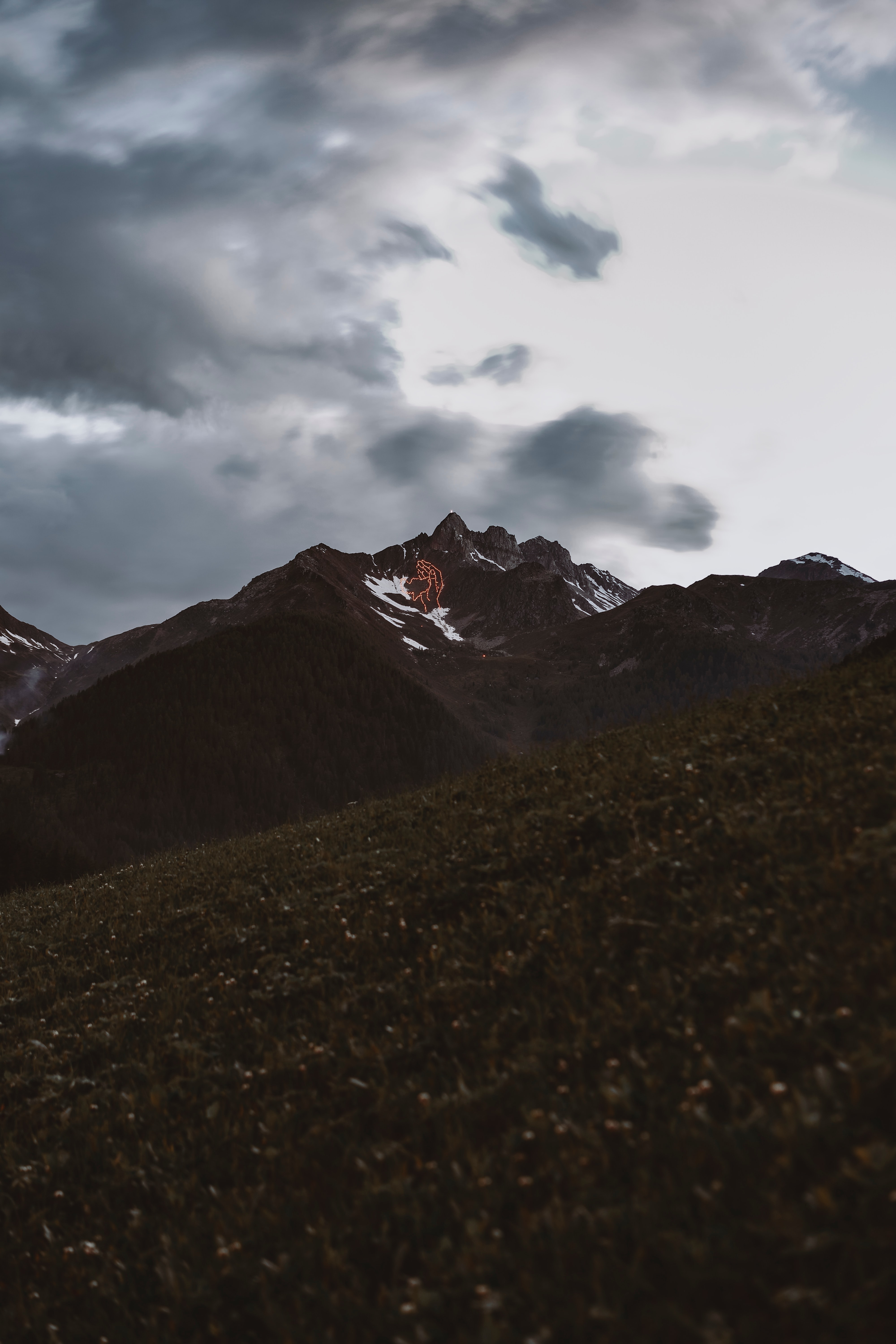 Download wallpaper 4000x6000 mountains, slope, rocks, grass, lights ...
