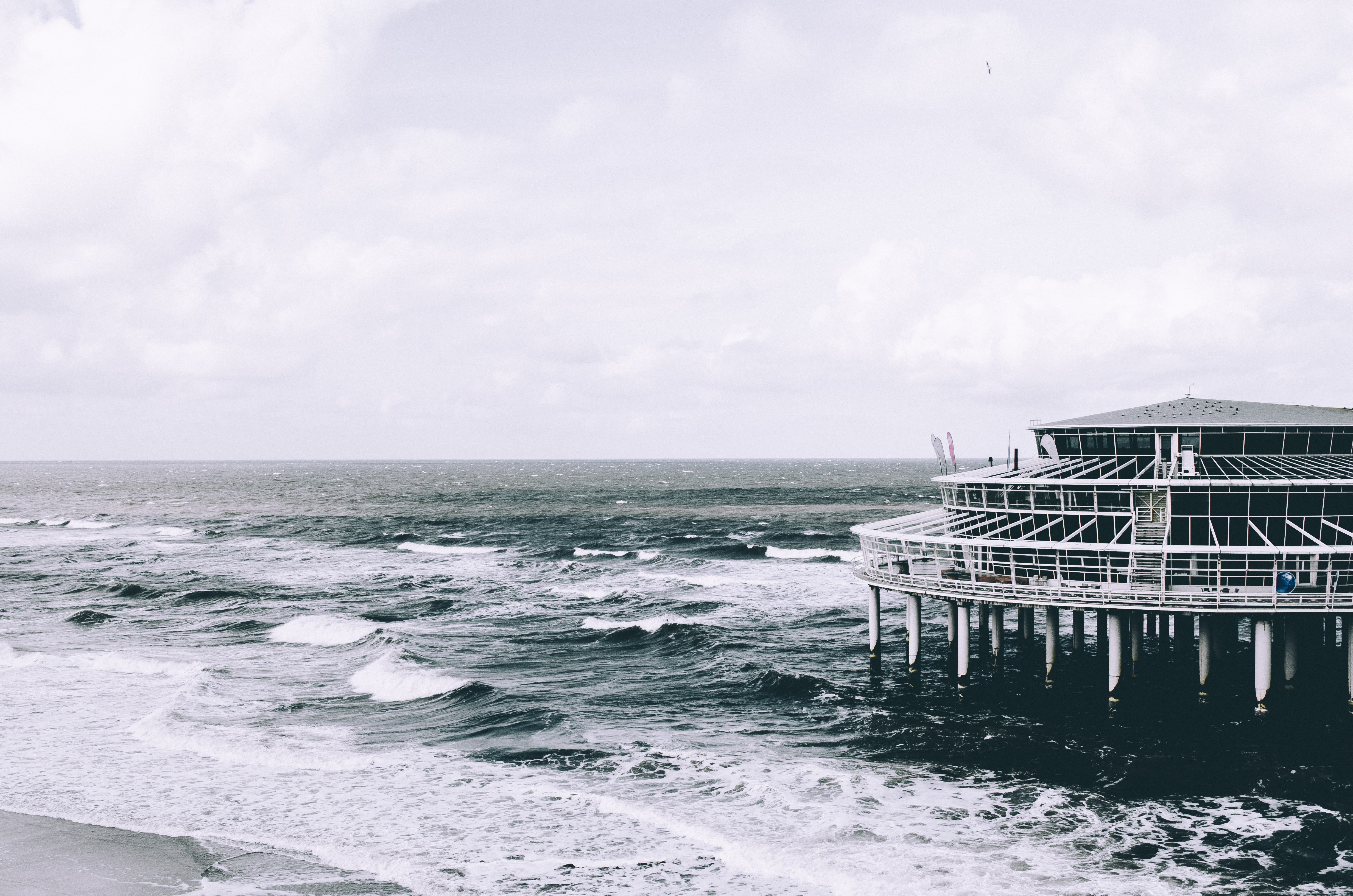 Download wallpaper 4928x3264 sea, structure, surf, piles hd background