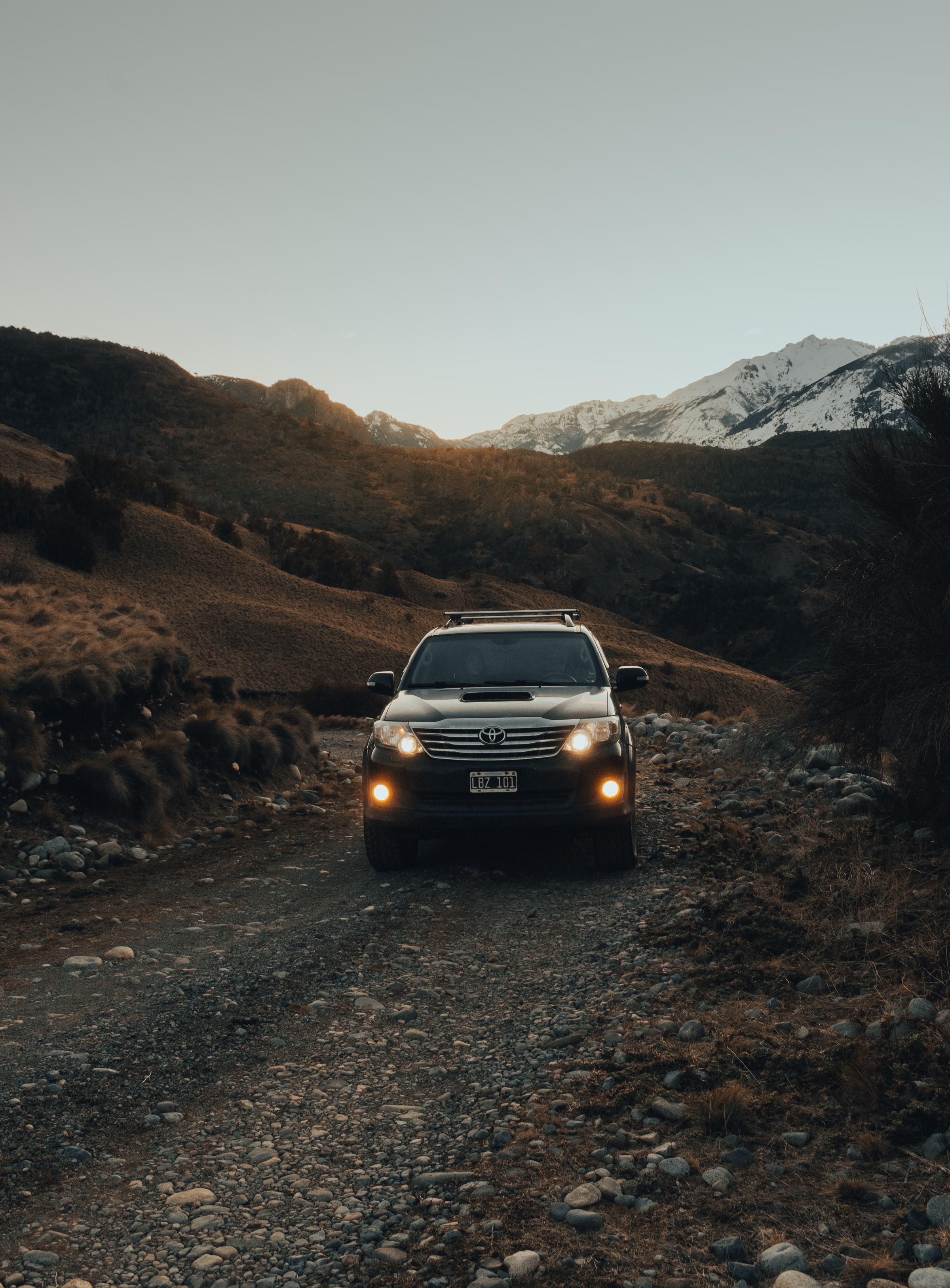 Download wallpaper 2400x3252 toyota, car, suv, front view, road, rock ...